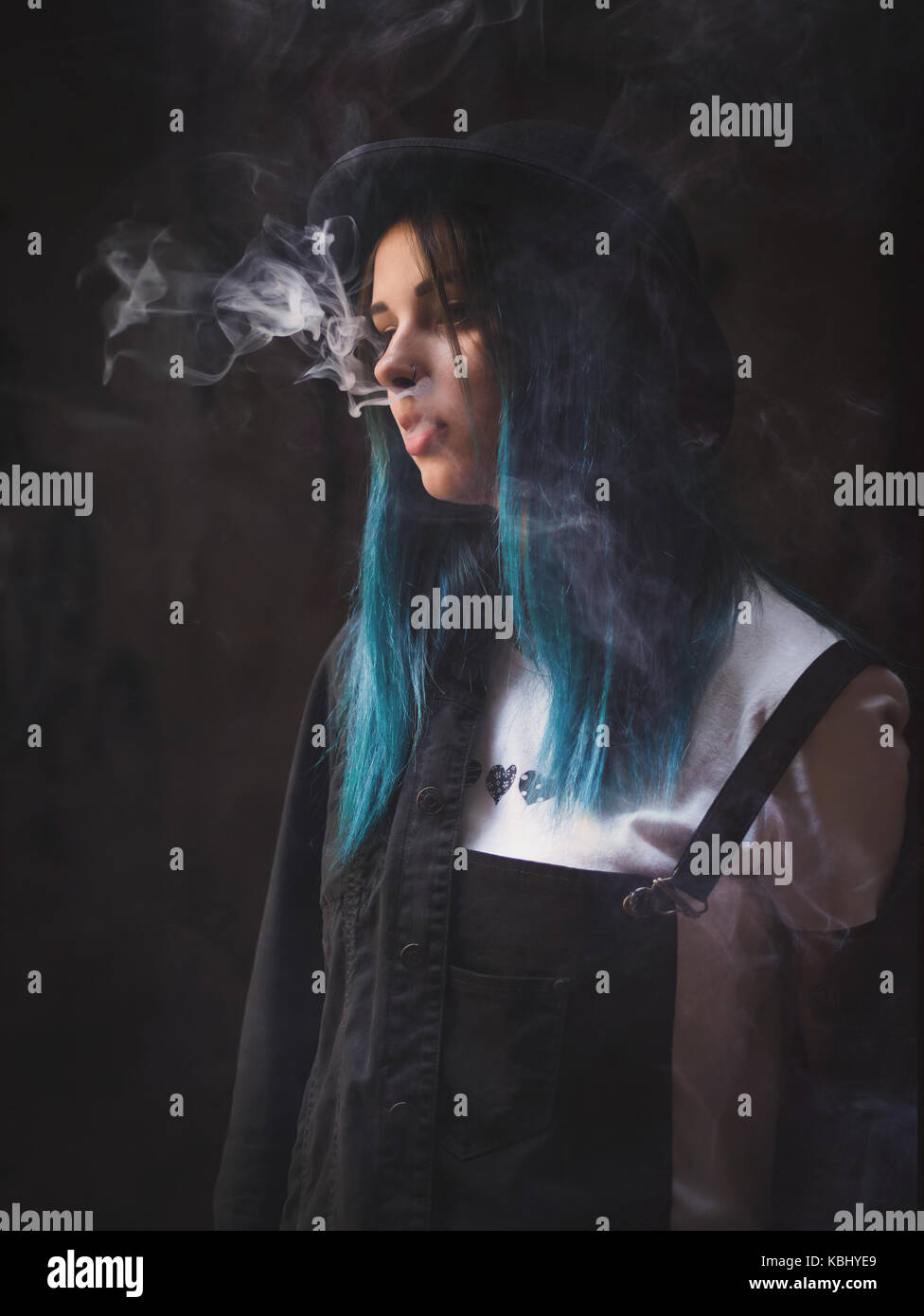 Emo girl smoking cigarette.Street punk or hipster woman with blue ...