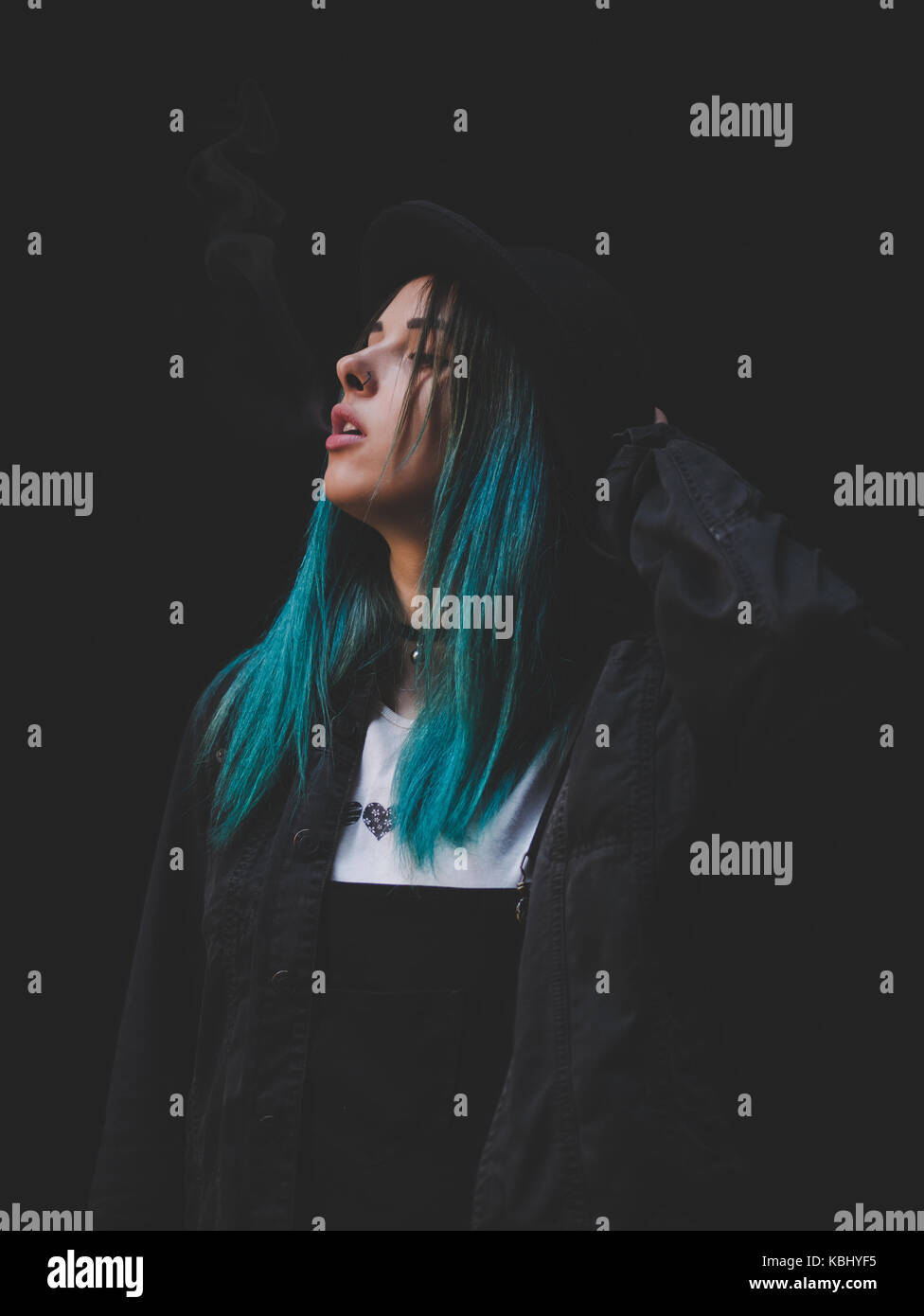 Emo girl smoking cigarette.Street punk or hipster woman with blue ...