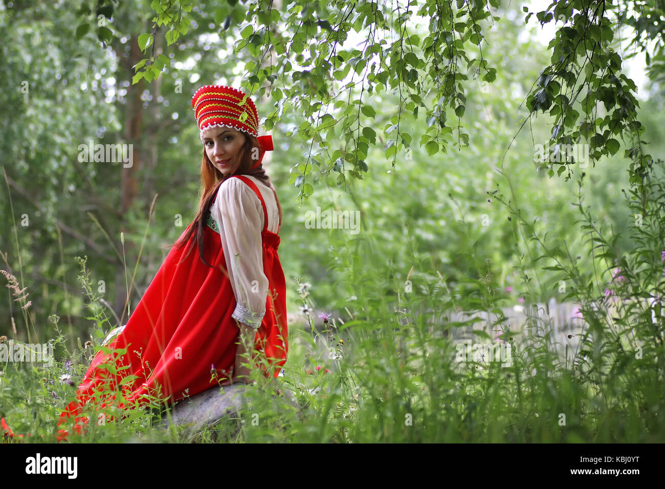 Slav in traditional dress is sitting in nature Stock Photo - Alamy