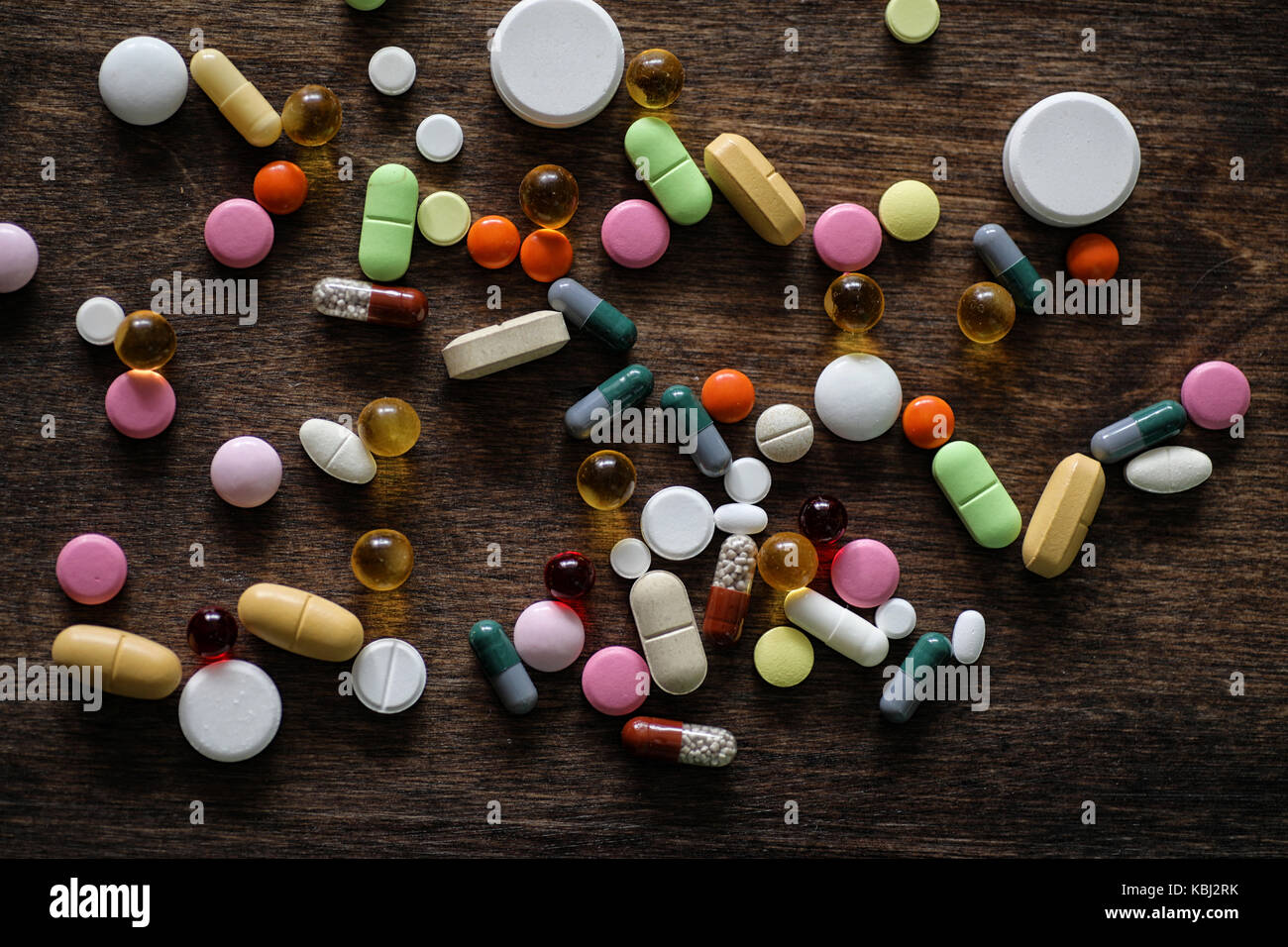 Medications on a textured wooden background Stock Photo - Alamy