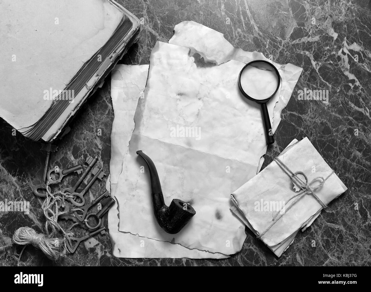 papers and book on detective work table with tools Stock Photo - Alamy