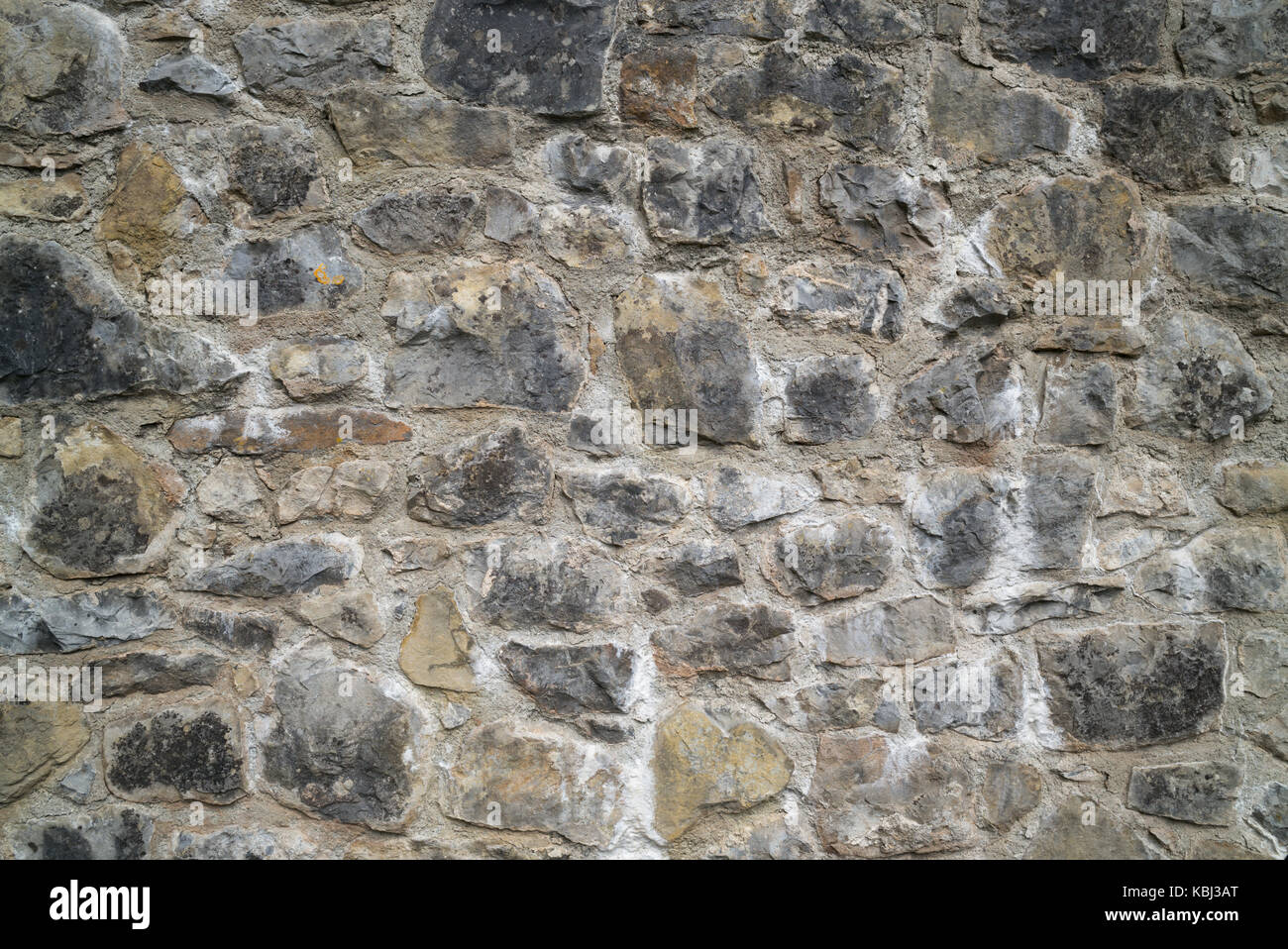 Rough stone block wall with mortar cement of reconstructed barn. St ...
