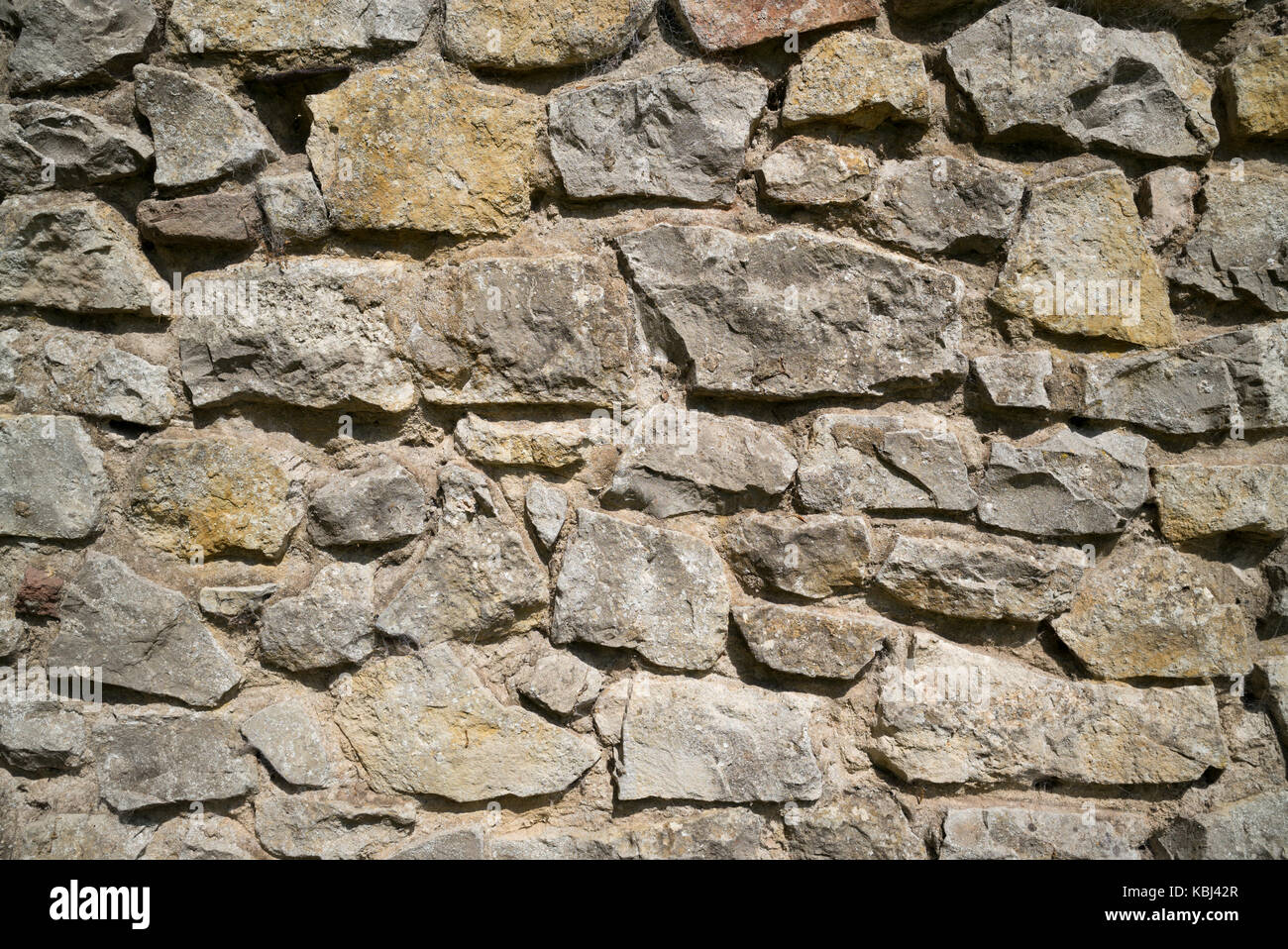 Rough stone block wall with mortar cement of reconstructed barn. St ...