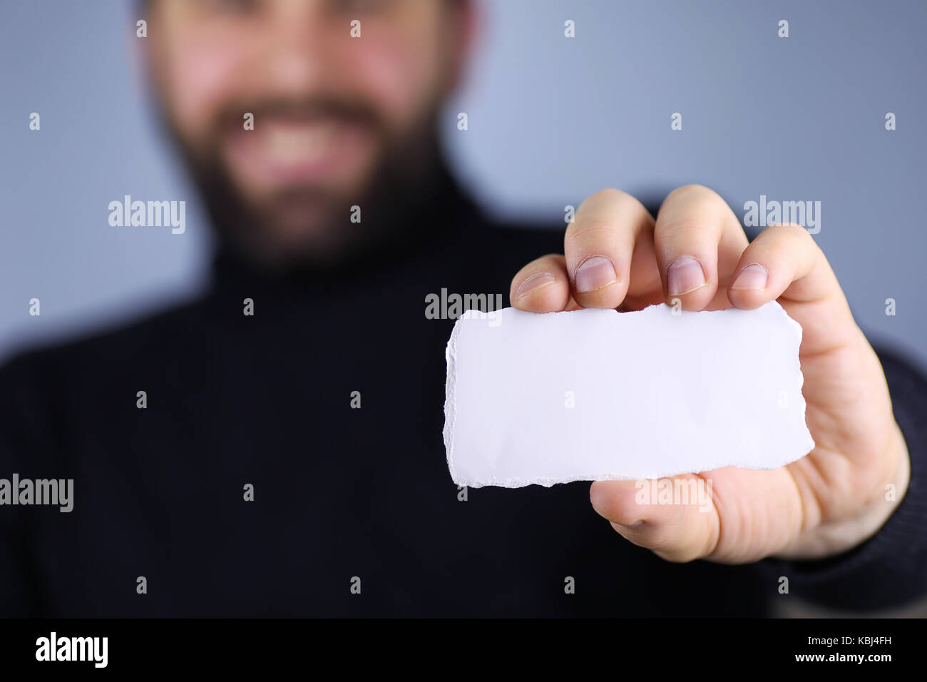 small white piece of paper in his hand man Stock Photo - Alamy