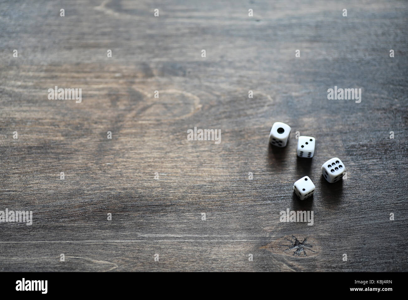 White dices on a brown wooden texture table Stock Photo - Alamy