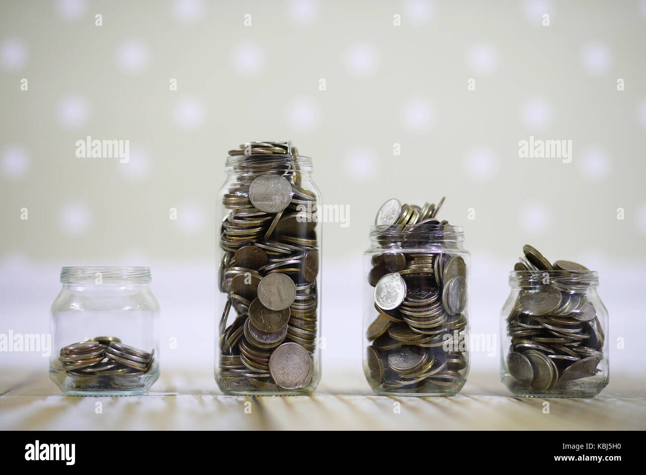 coins stacked in glass jars on the floor russian rubles Stock Photo - Alamy