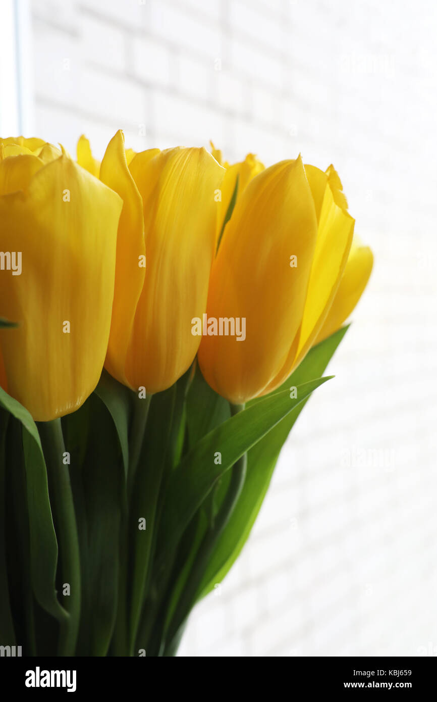 A bouquet of fresh yellow tulips in a vase Stock Photo - Alamy