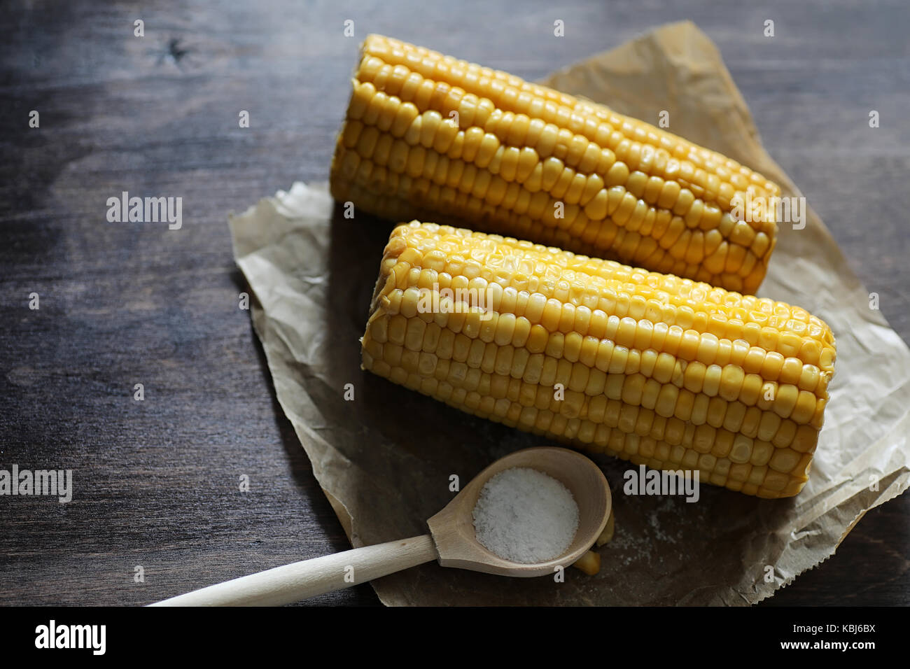 Boiled corn cob with salt on a wood Stock Photo - Alamy