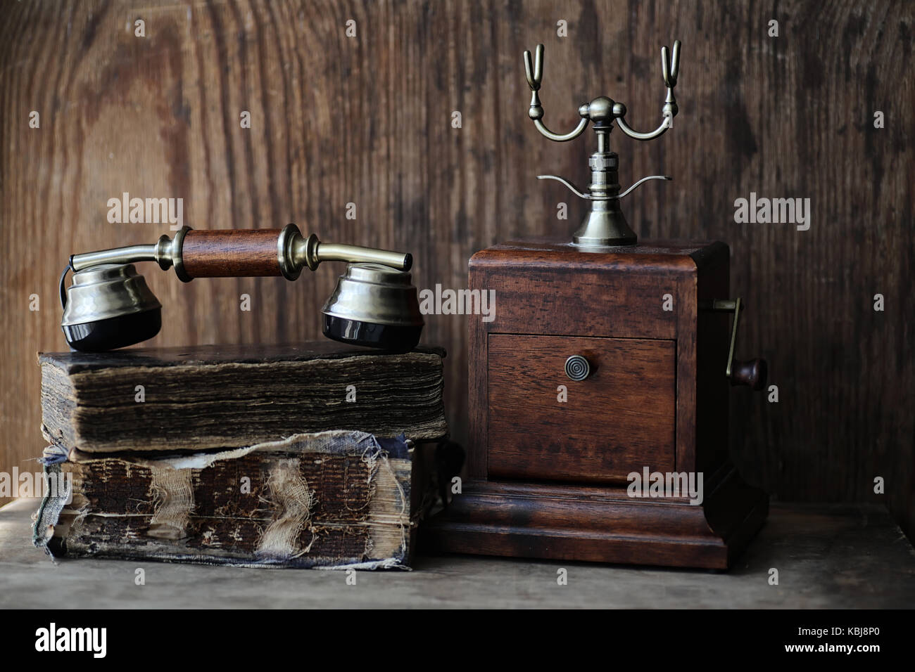 Old telephone and retro book on a wood Stock Photo - Alamy