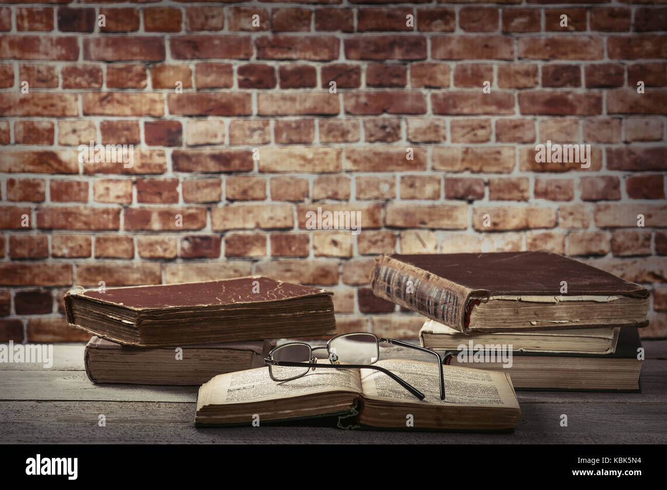 Old books on wooden table Stock Photo - Alamy