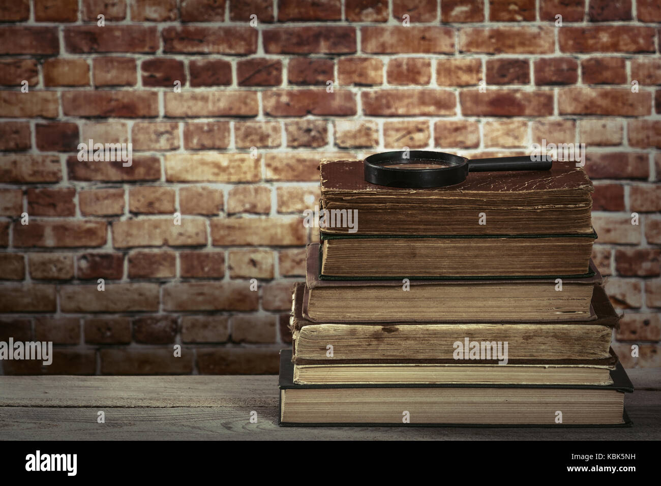 Old books on wooden table Stock Photo - Alamy