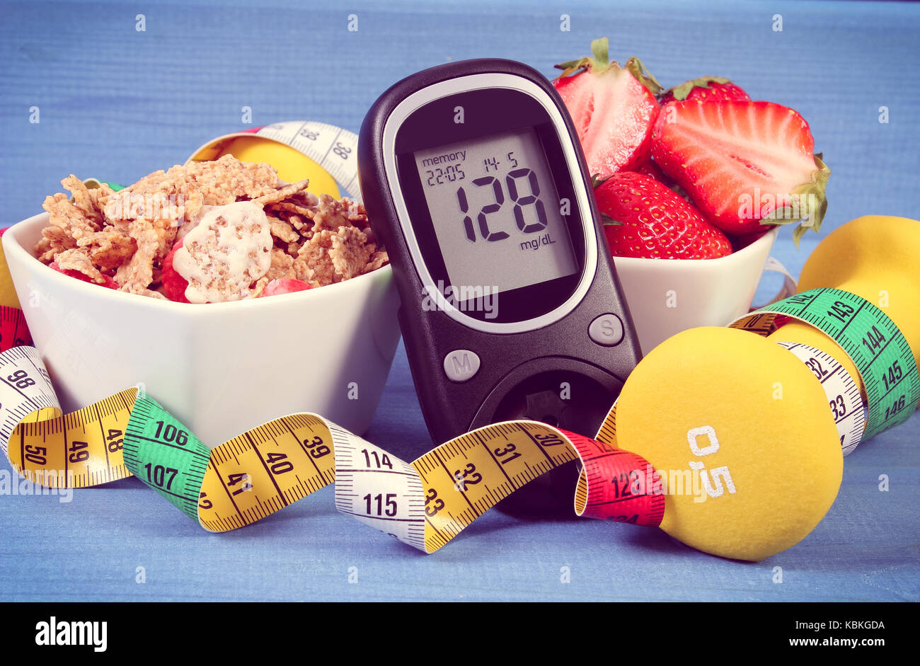Glucometer with sugar level, healthy food, dumbbells for fitness and ...
