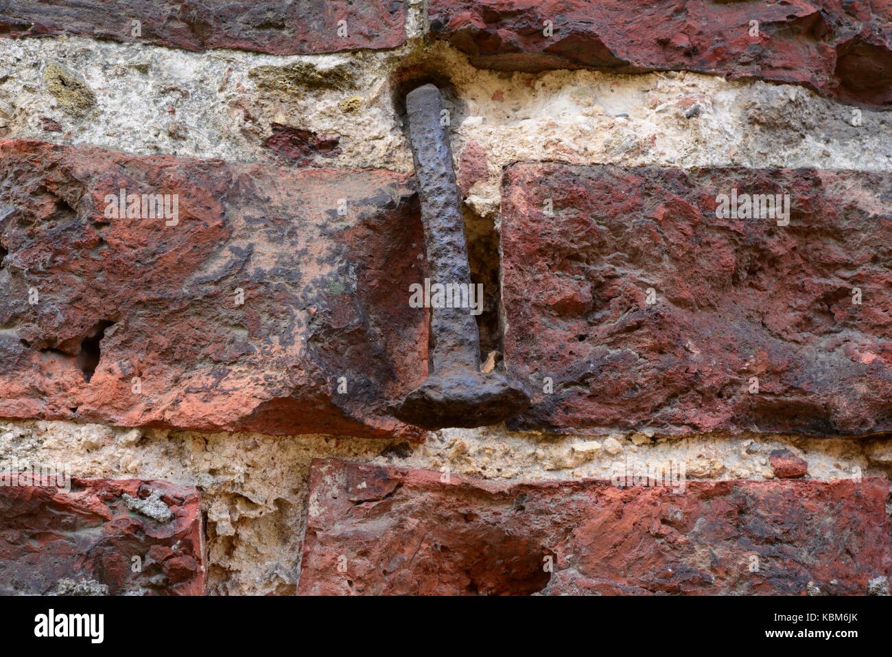 The old nail into the brick wall of ancient buildings Stock Photo - Alamy