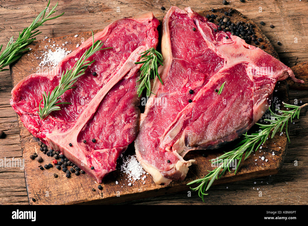 Raw fresh meat t-bone steak and seasoning on wooden background Stock ...