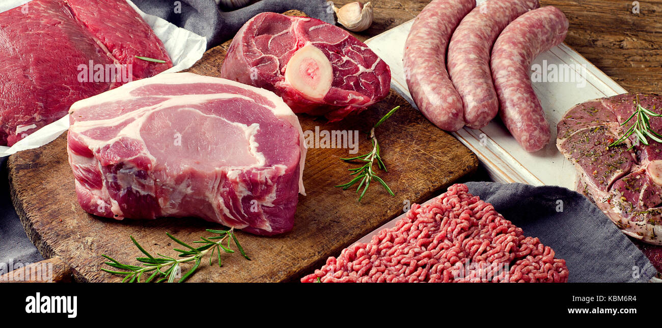 Different types of fresh raw meat on dark wooden background Stock Photo ...