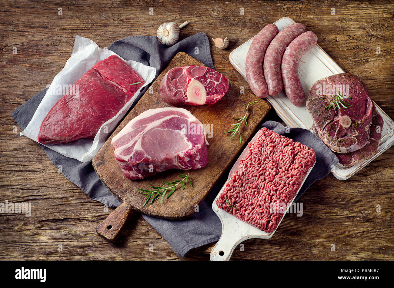 Different types of raw meat on a rustic wooden background. Top view ...