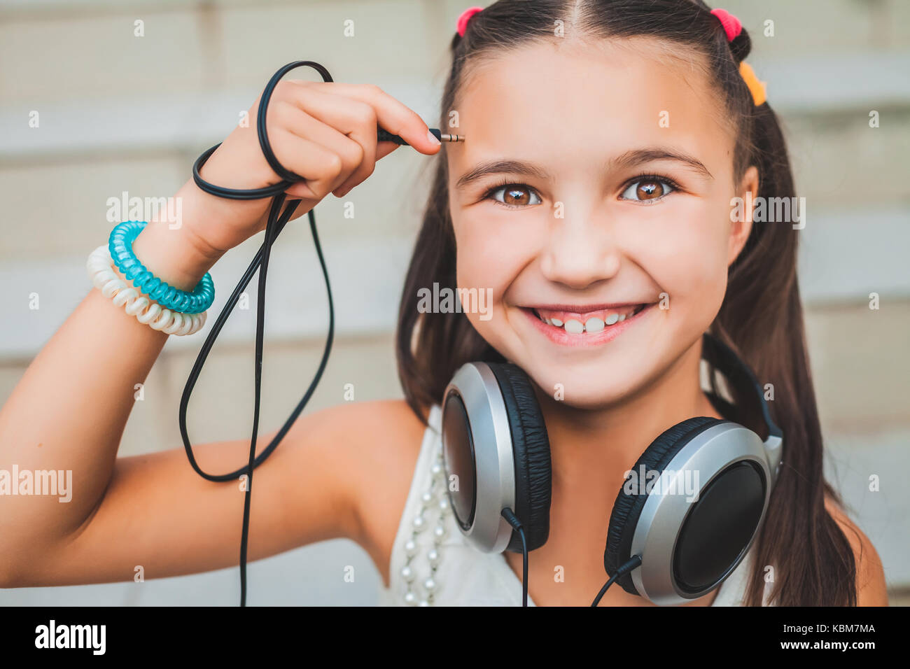 little child holding tangle wire and smiling, cute kid laughing out ...