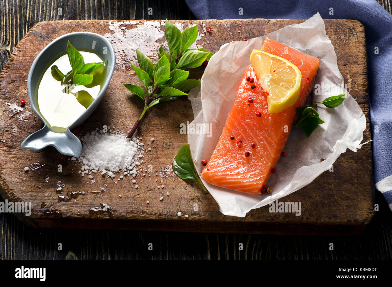 Portion of salmon fillet with herbs on wooden table. Top view Stock ...