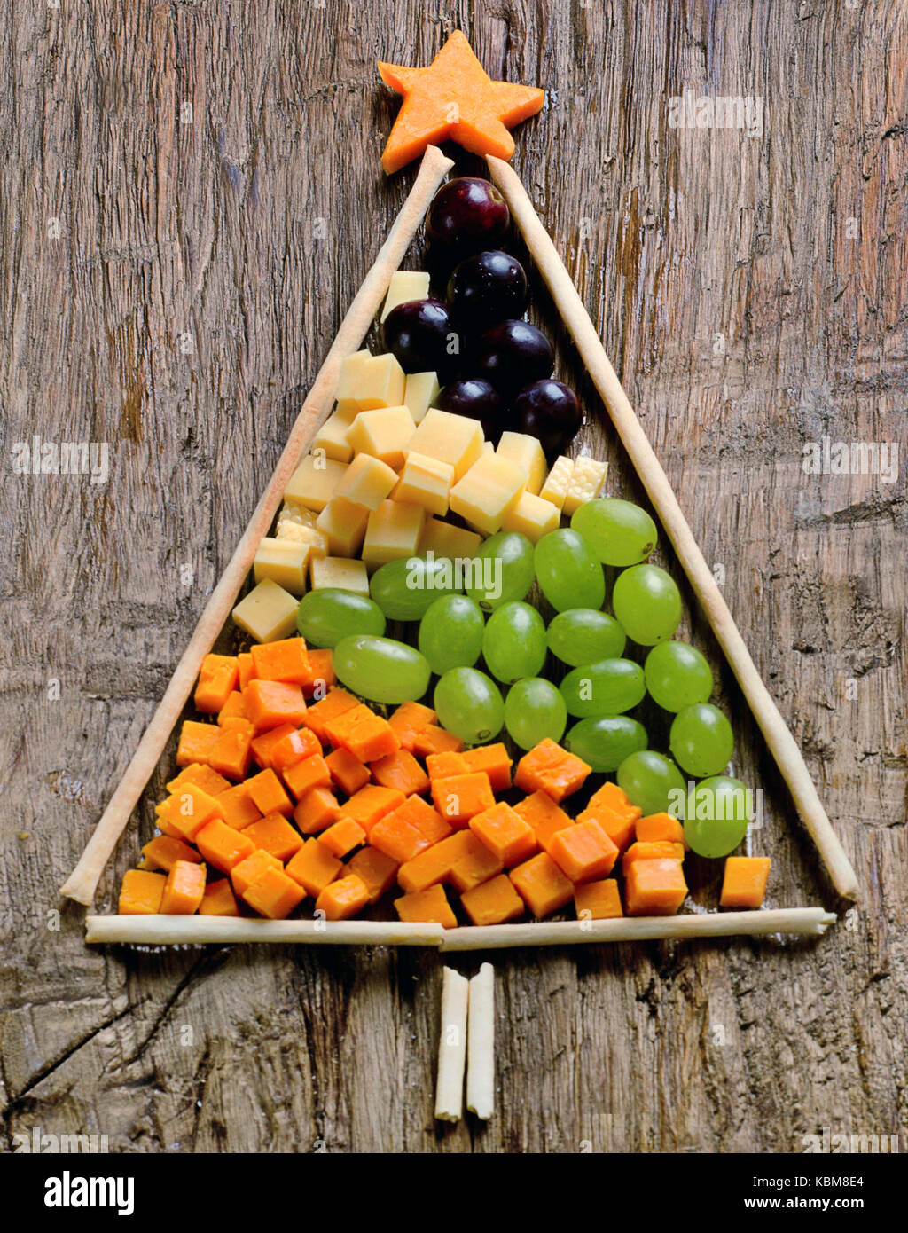 Christmas cheese and grape tree on wooden background. Top view Stock ...