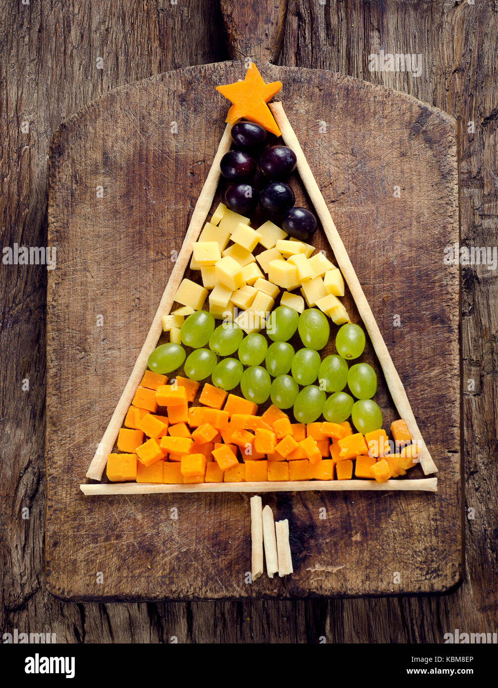 Christmas cheese and grape tree on a wooden background. Top view Stock ...