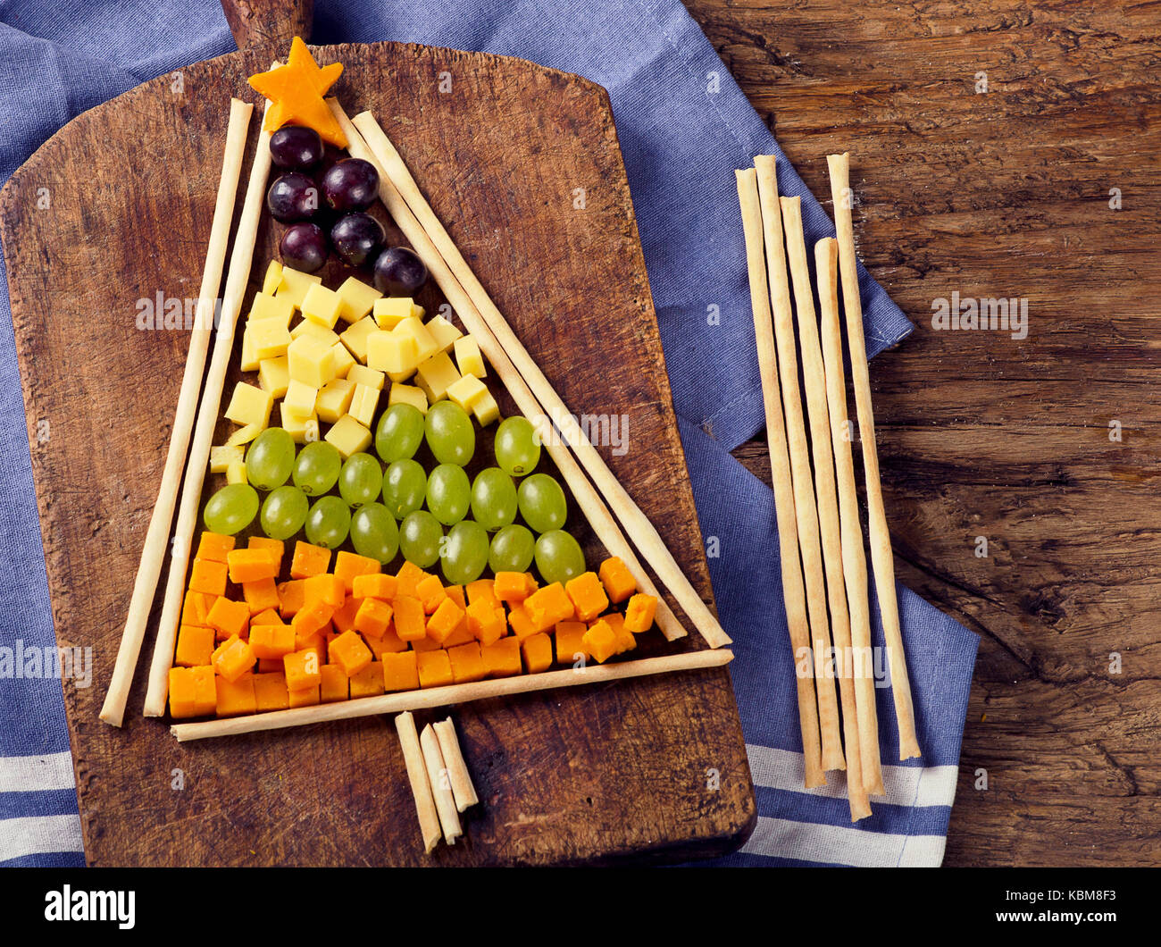 Christmas cheese and grape tree on wooden table. Top view Stock Photo ...