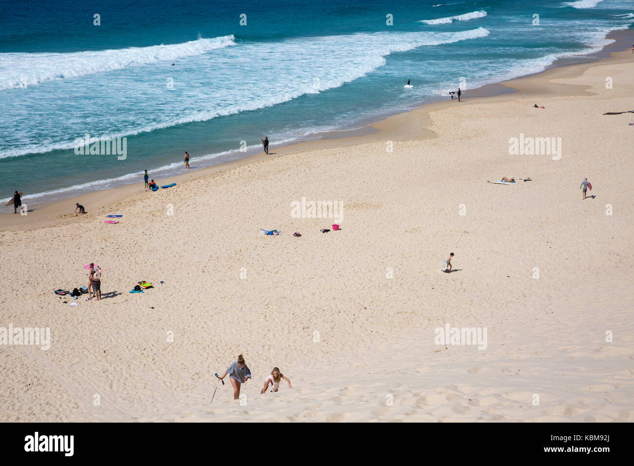People enjoying a spring day on One Mile Beach at Forster on the mid ...