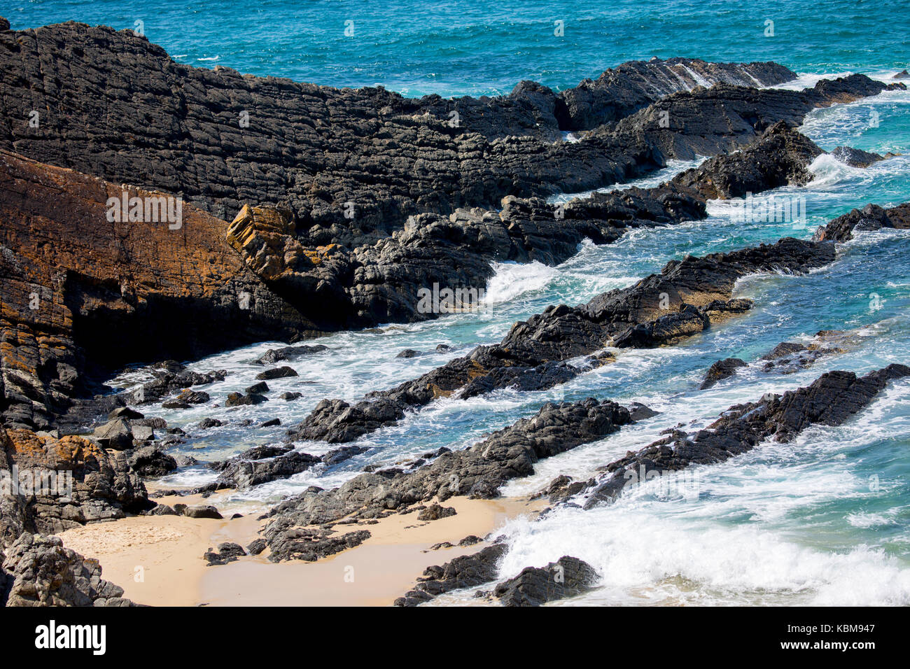 Rugged coastline at the northern end of One mile beach, Forster, mid ...