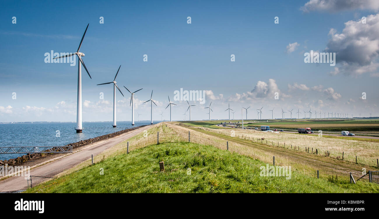 Windmills in a row near highway Stock Photo - Alamy