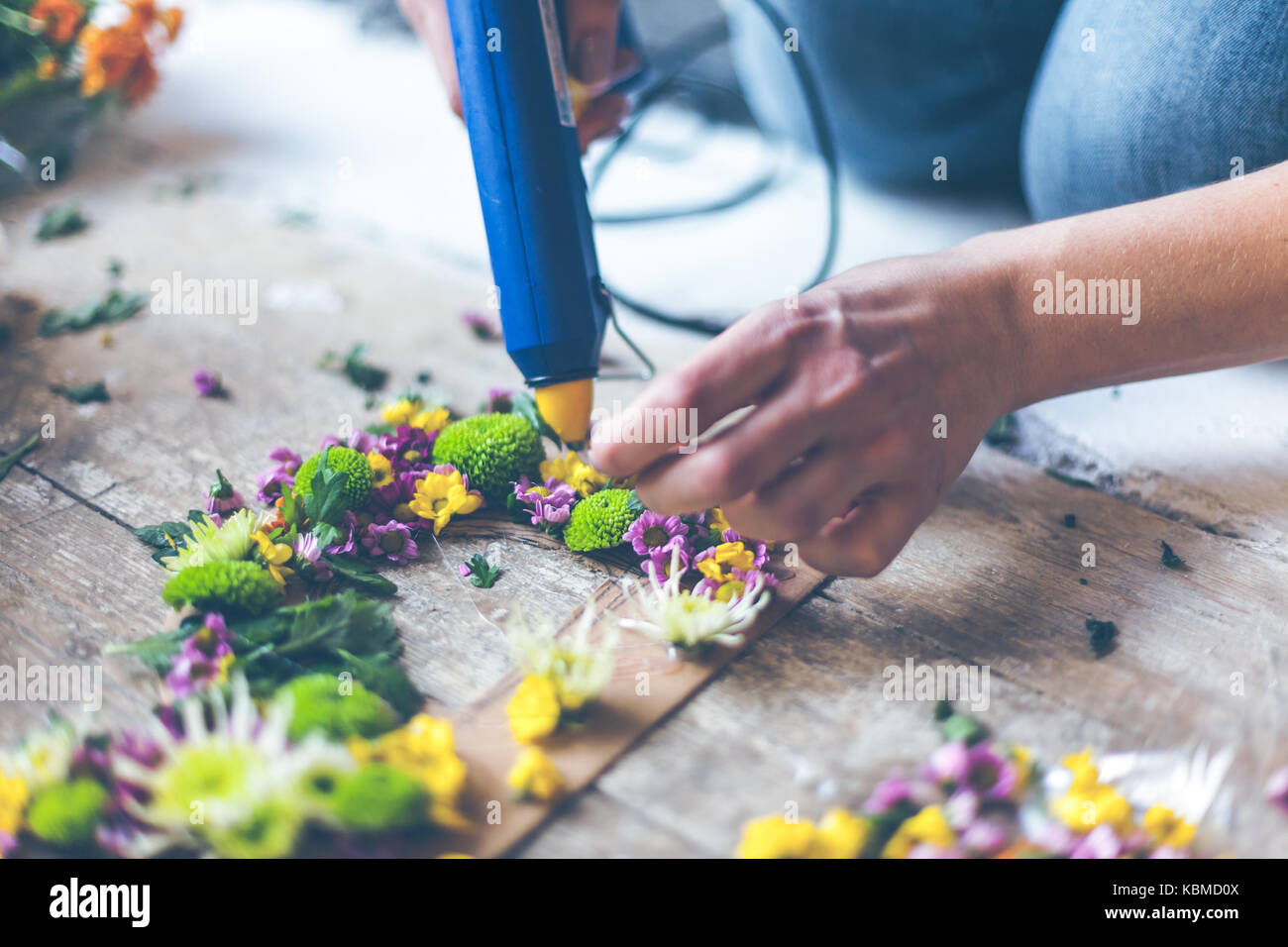 Florist making flower decoration with letters and glue. Indoors natural ...