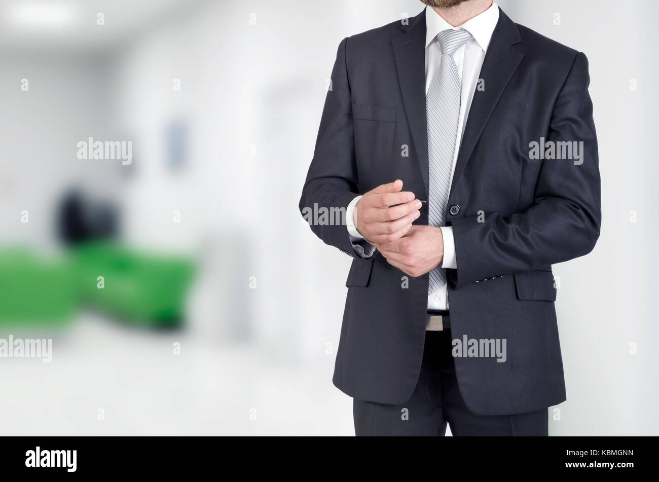 Portrait of unrecognizable businessman standing in modern white office ...