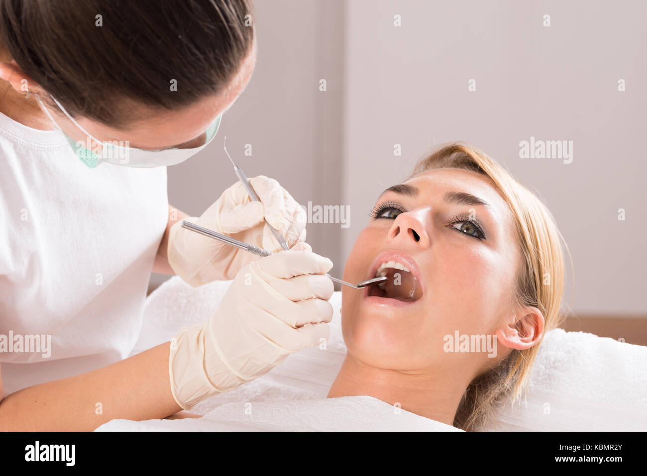 Young female patient getting dental checkup at clinic Stock Photo - Alamy