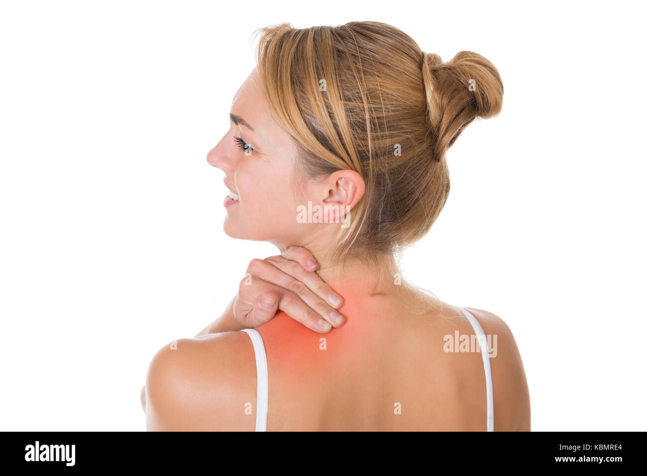 Rear view of sad young woman suffering from shoulder pain over white ...