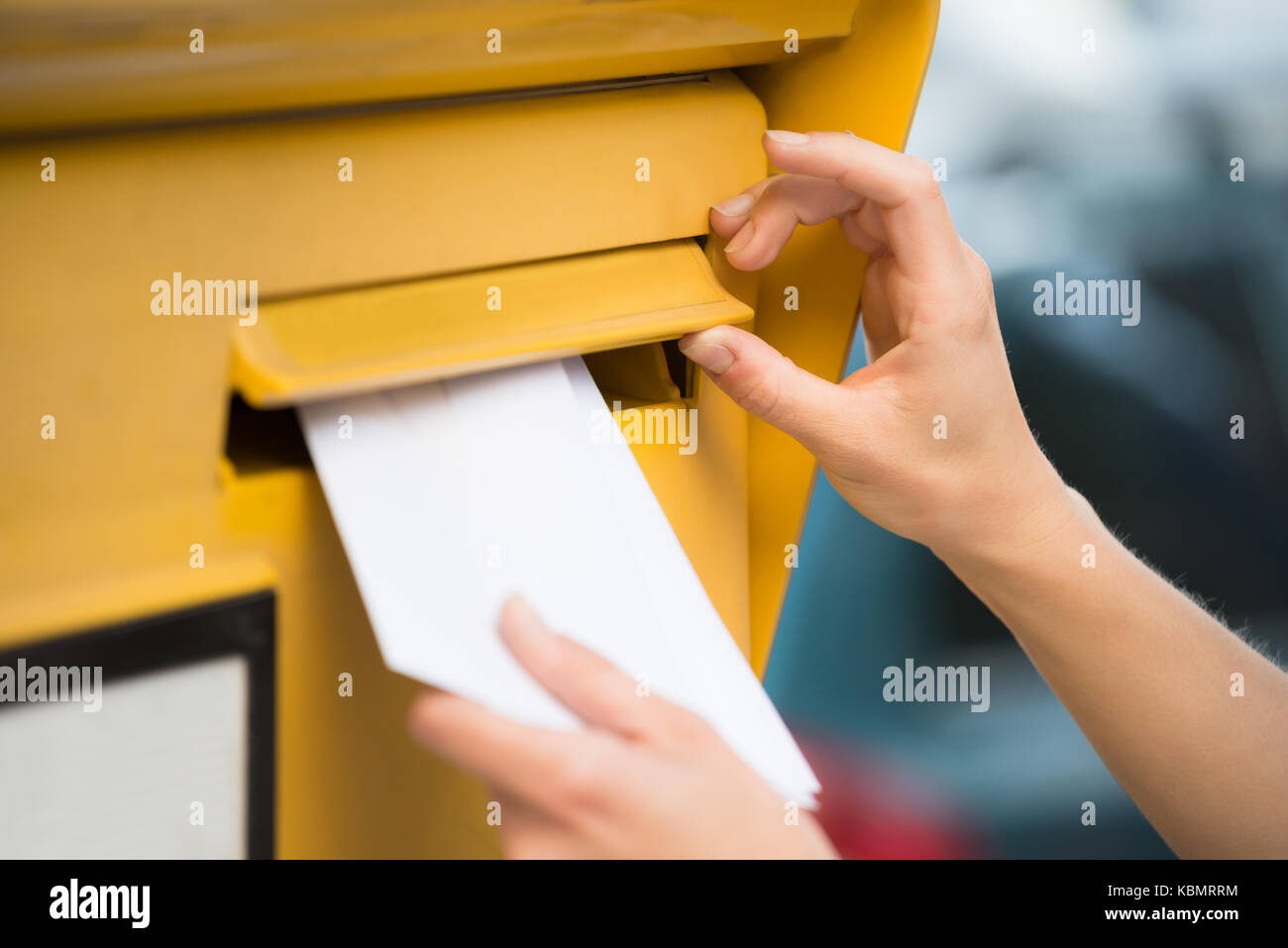 Closeup of woman's hands inserting letter in mailbox Stock Photo - Alamy