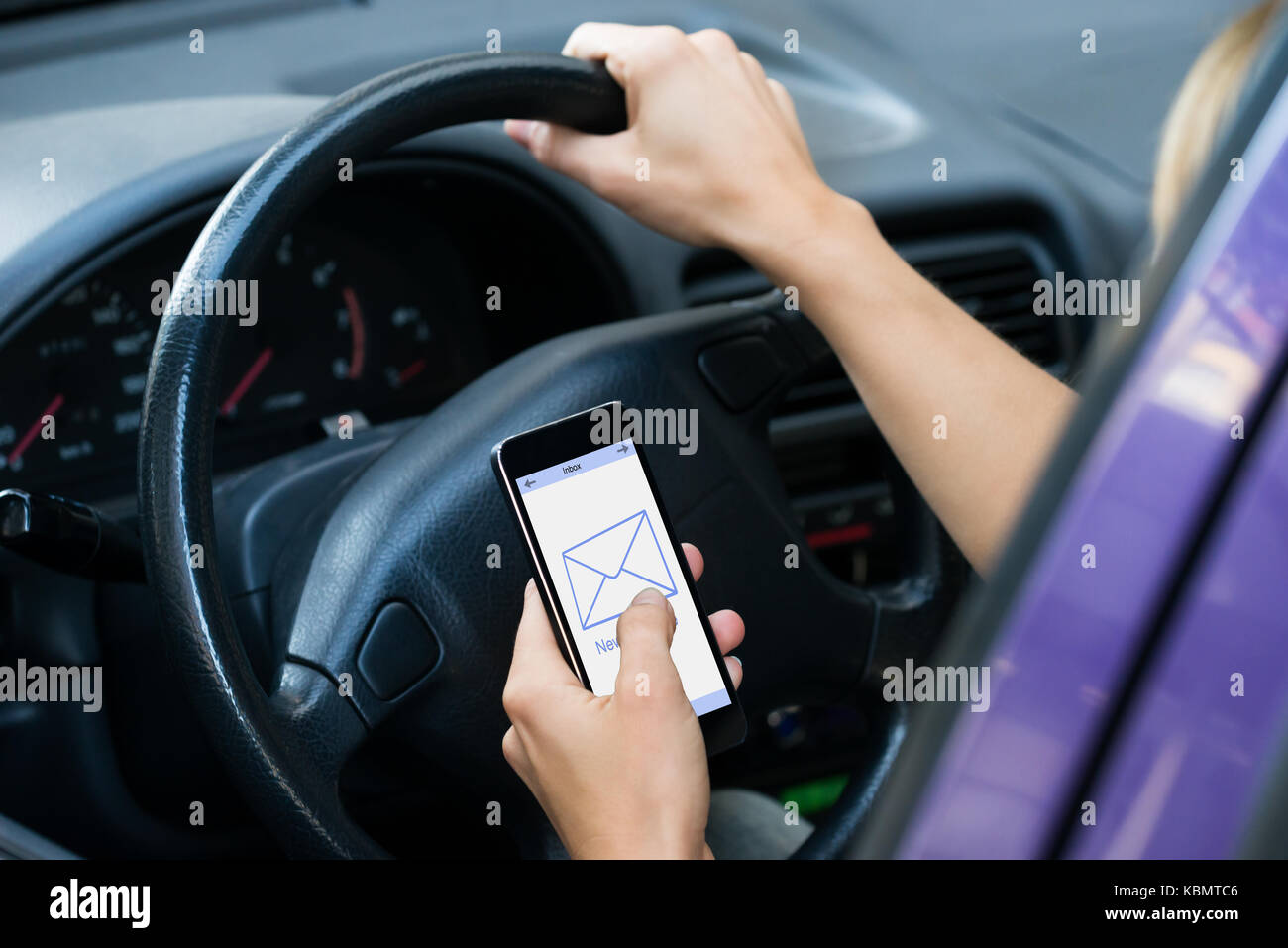 Cropped image of hands checking message while driving car Stock Photo ...