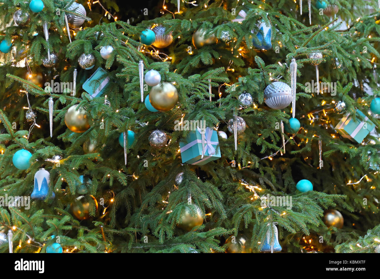 Beautiful Christmas tree with gifts and icicles Stock Photo - Alamy