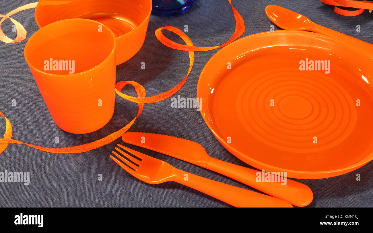 colored orange plates on the prepared table to celebrate a birthday ...