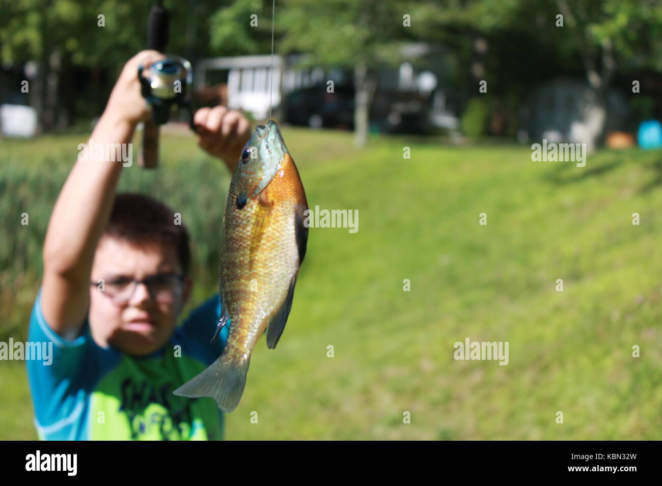 A young fisherman shows off his catch Stock Photo - Alamy