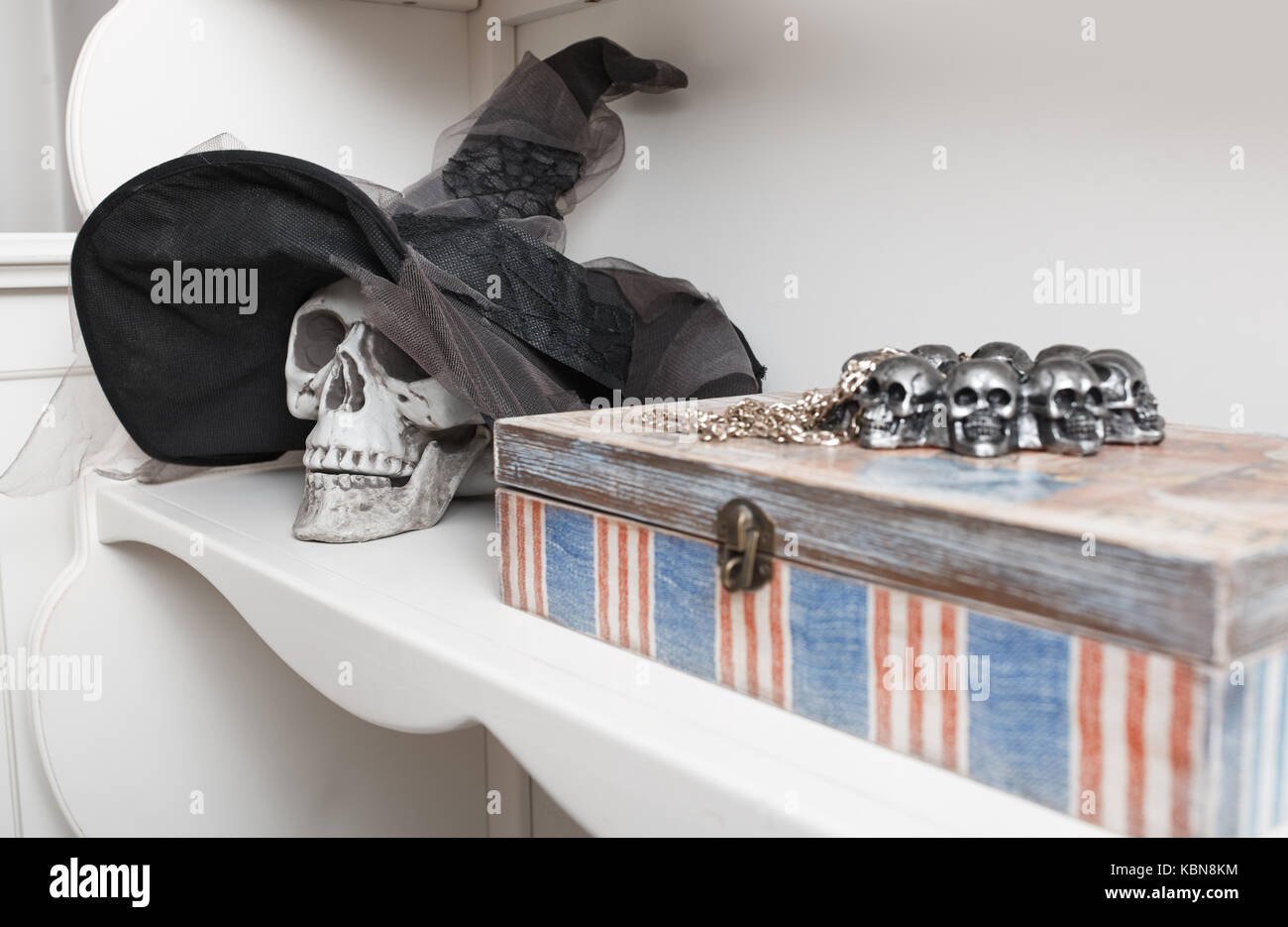 Human skull in a white cabinet. Halloween theme Stock Photo - Alamy