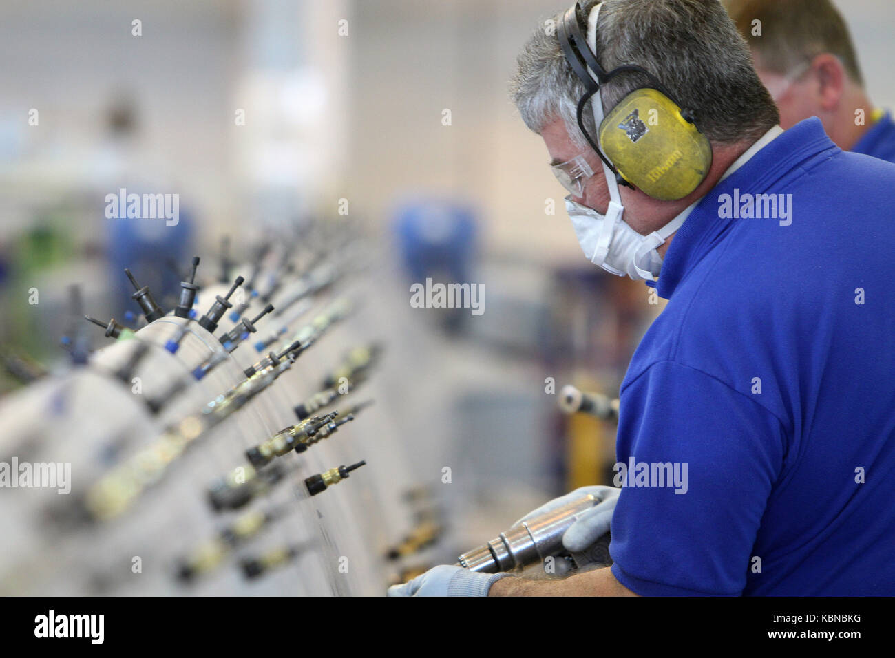 Blue collar workers in manufacturing Stock Photo - Alamy