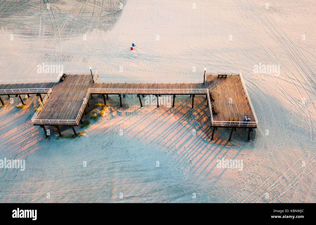 Aerial view of a wooden dock on sandy beach Stock Photo - Alamy