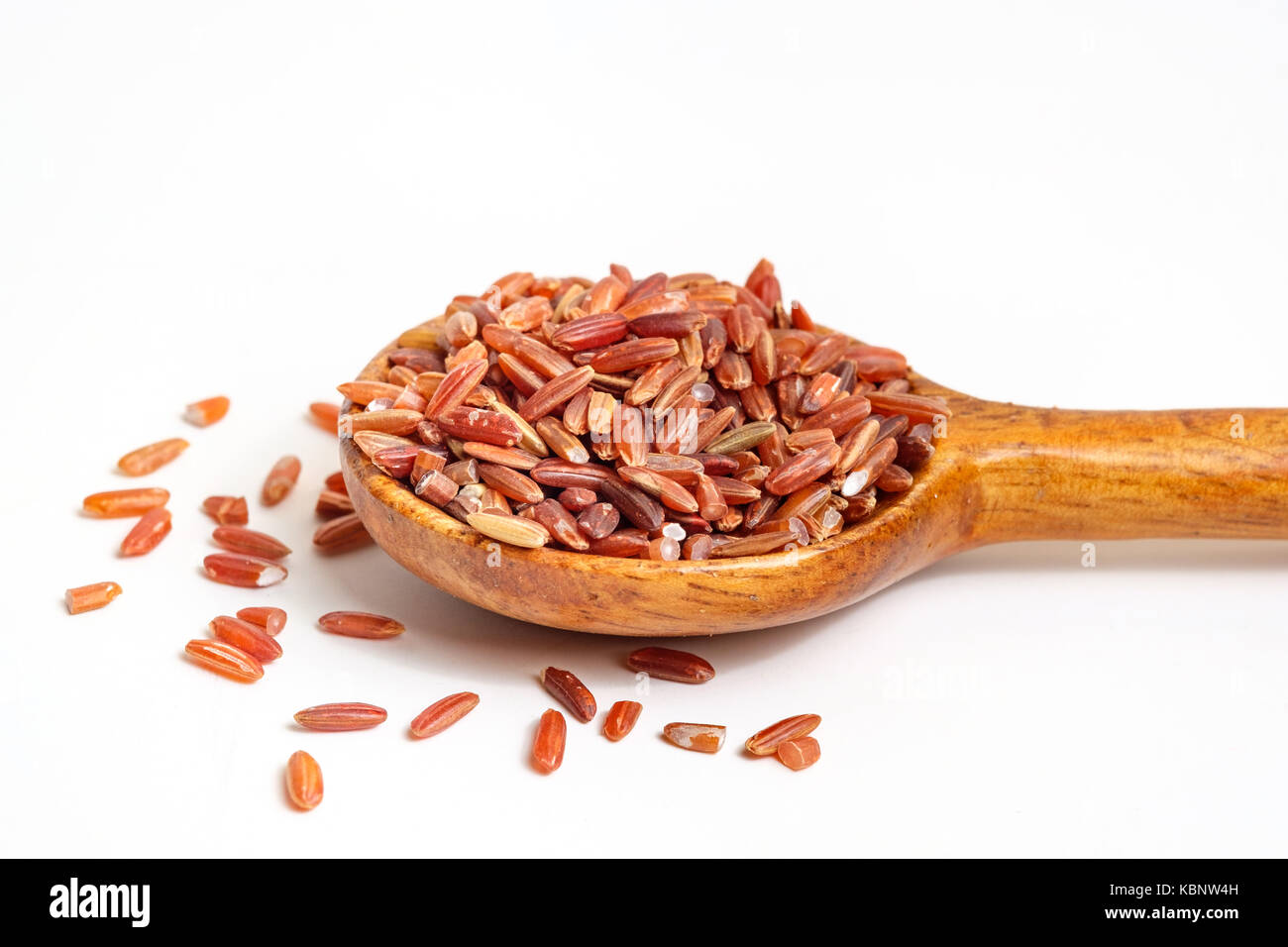 Red rice on wooden spoon Stock Photo - Alamy