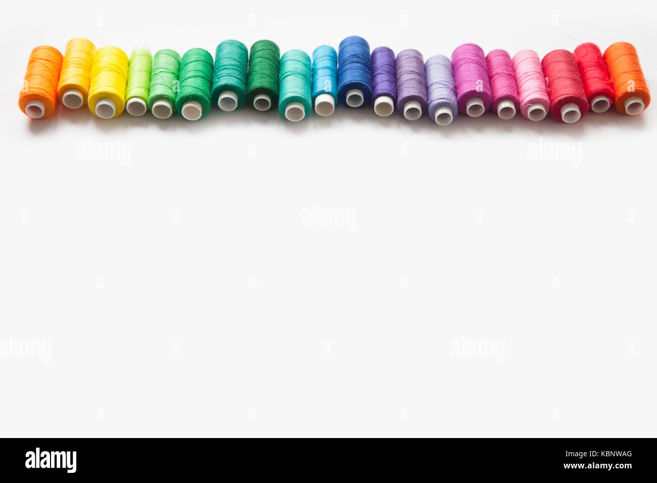Color thread for sewing. White background Stock Photo - Alamy