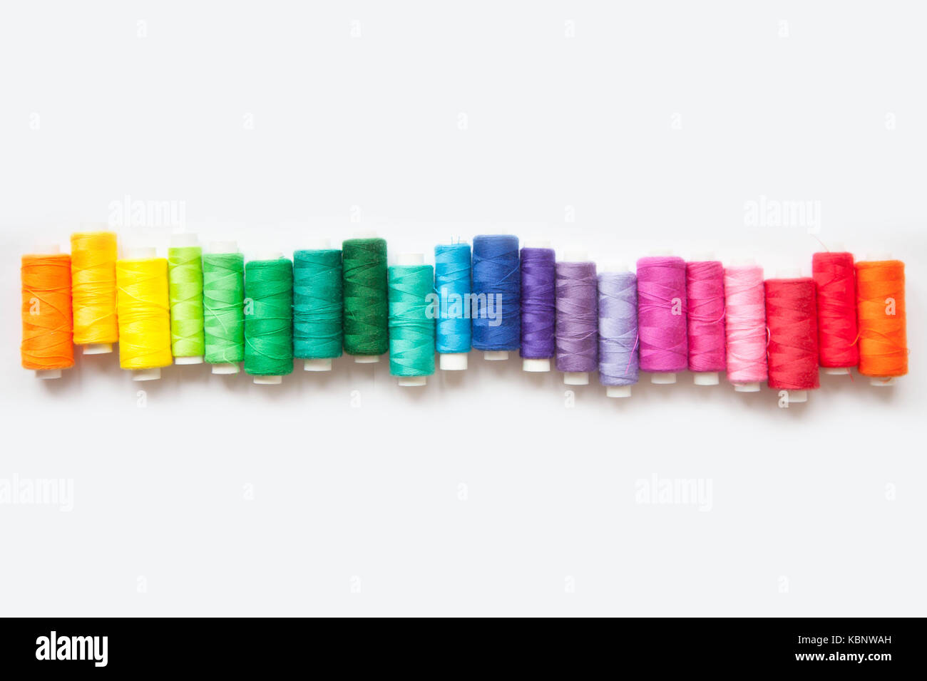 Color thread for sewing. White background Stock Photo - Alamy