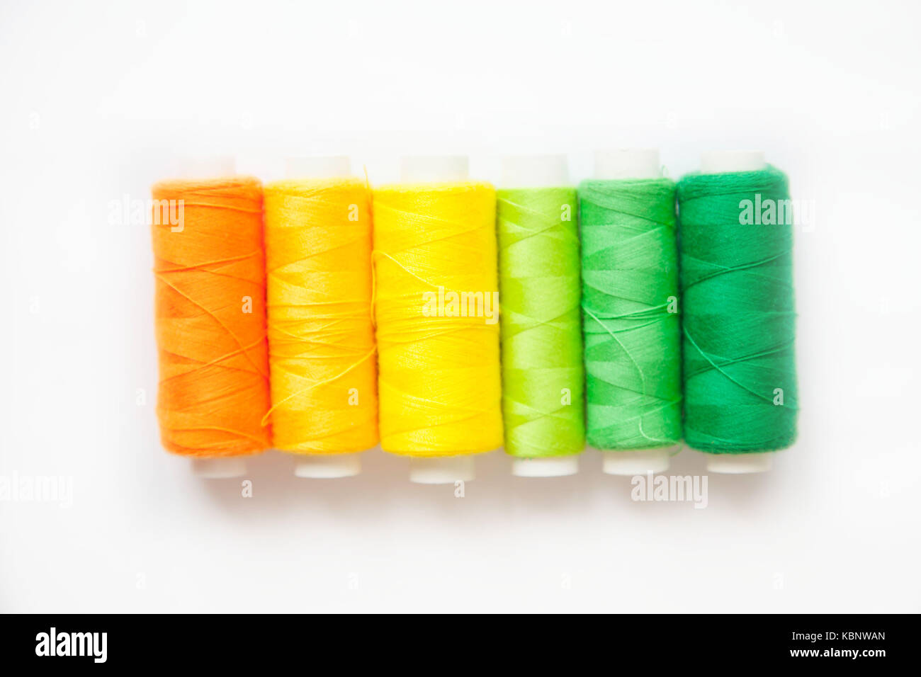 Color thread for sewing. White background Stock Photo - Alamy