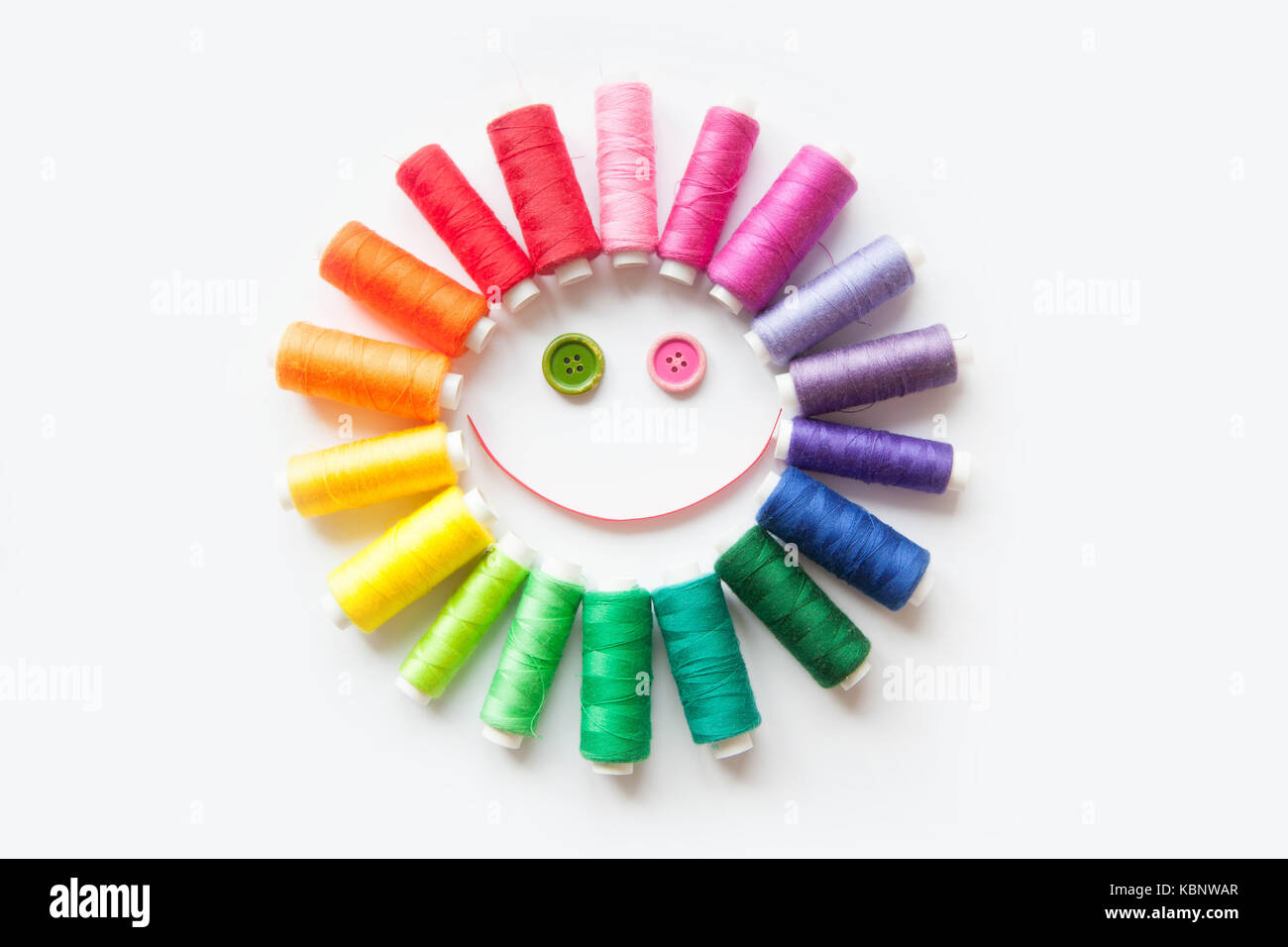 Color thread for sewing. White background. A circle of thread reels ...
