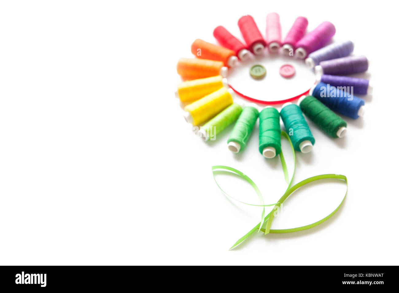 Color thread for sewing. White background. A circle of thread reels ...