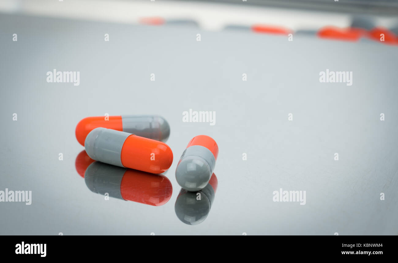 Colorful of antibiotic capsules pills with shadows on stainless steel ...