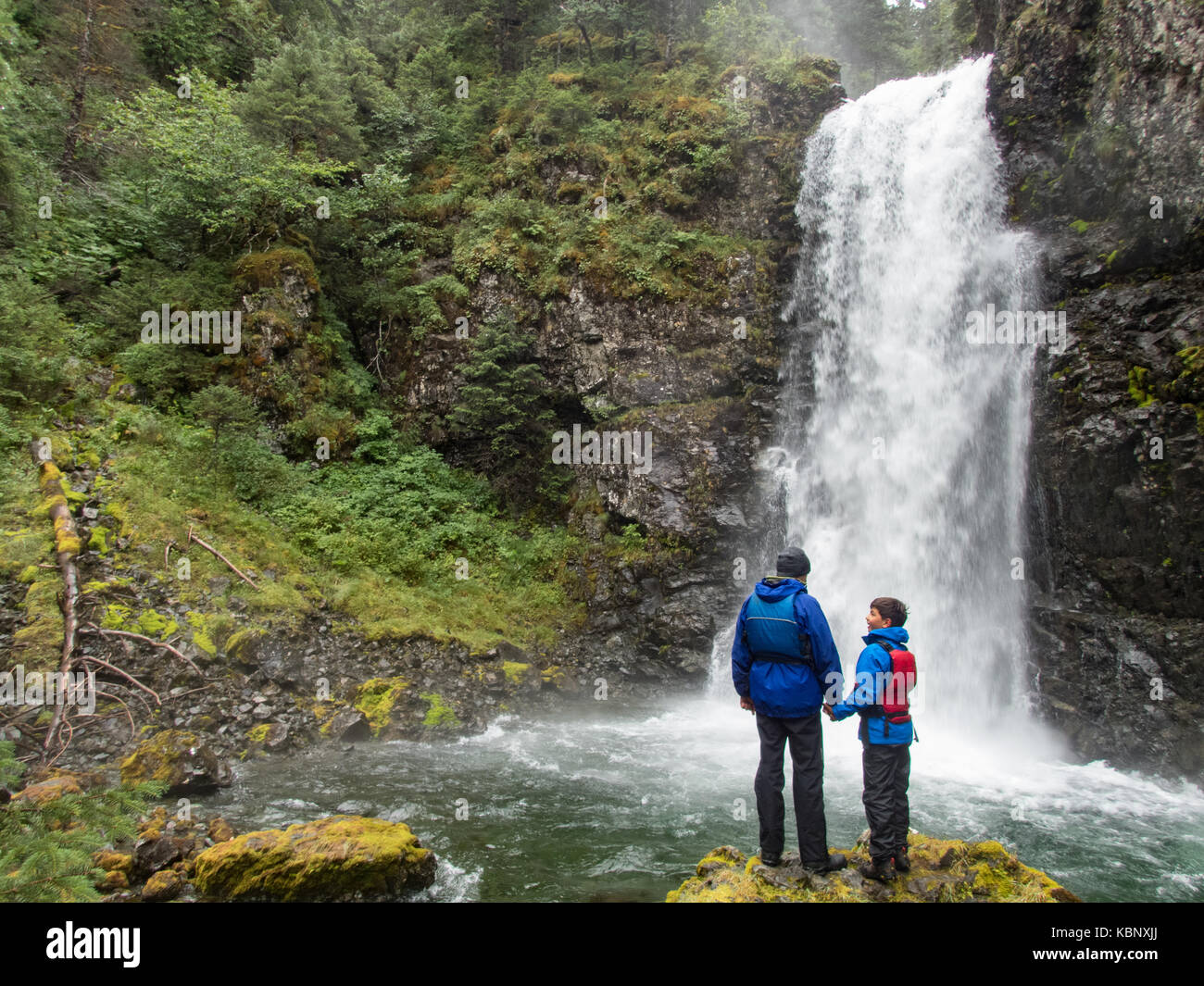 Father and 10 year old son holding hands and discovering remote ...