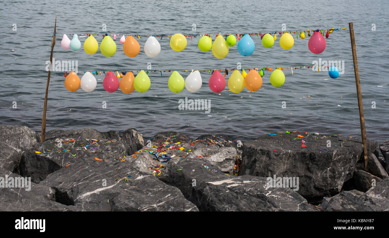 Balloon shooting game with balloons tied on a string Stock Photo - Alamy