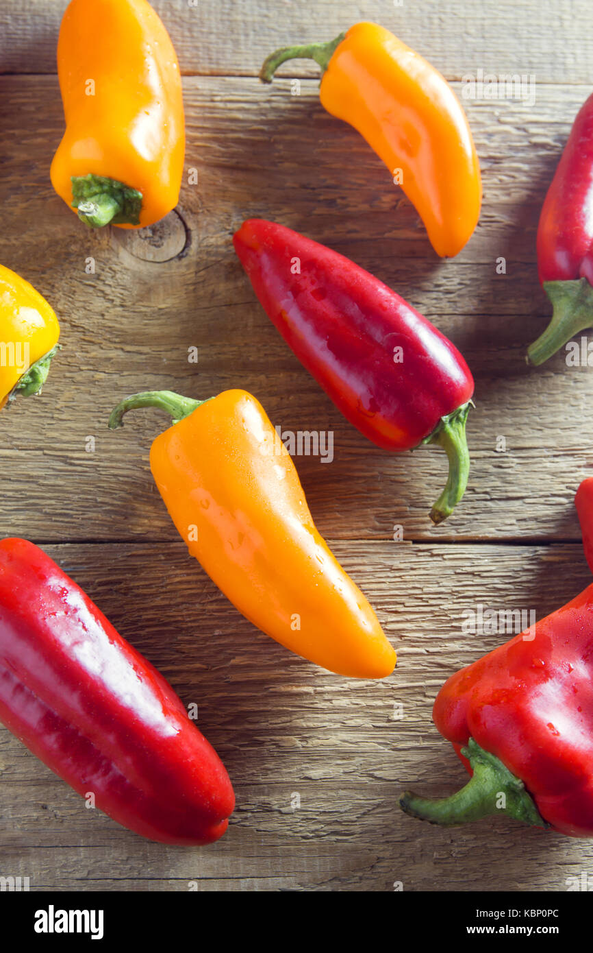 Fresh sweet organic paprika peppers on wooden background - healthy raw ...